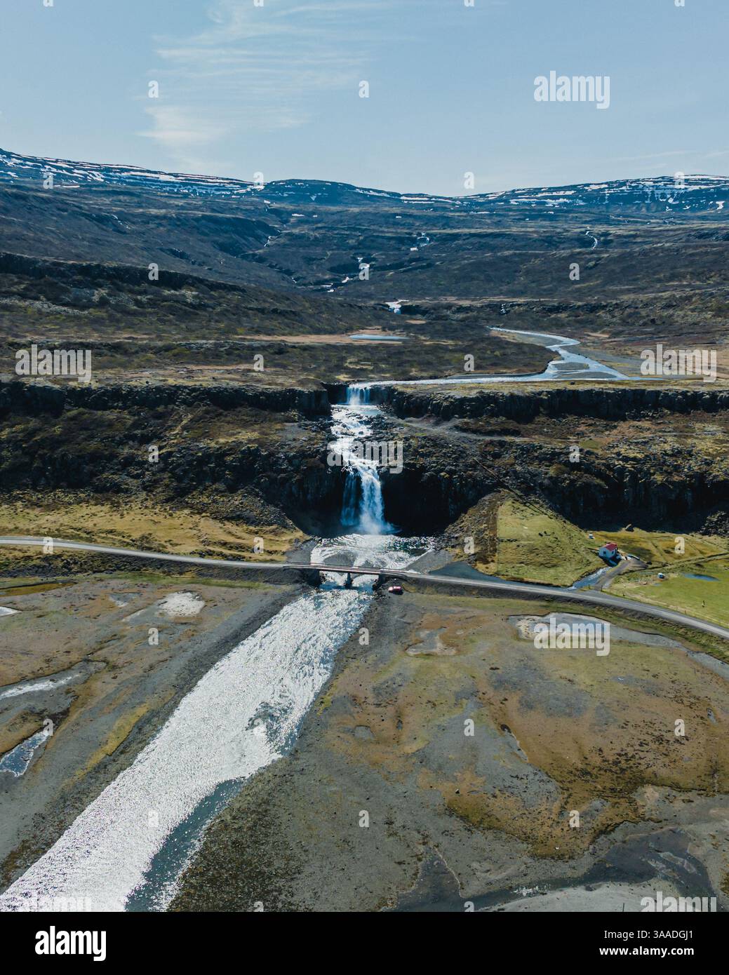 Aerial view of Foss Waterfall flowing through Fossfjordur valley ...