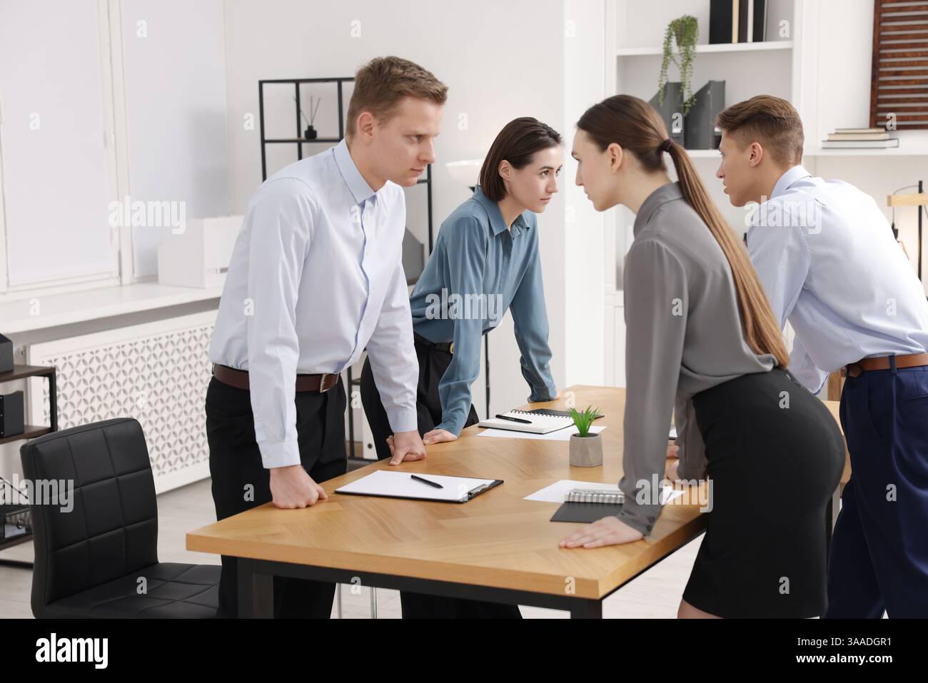 Competition concept. Group of businesspeople looking and examining each ...
