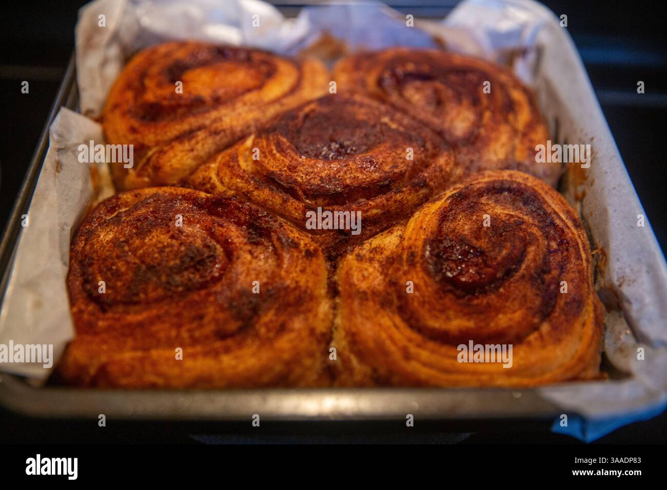 Finished Baked Cinnamon Rolls smooshed in a tray Stock Photo - Alamy