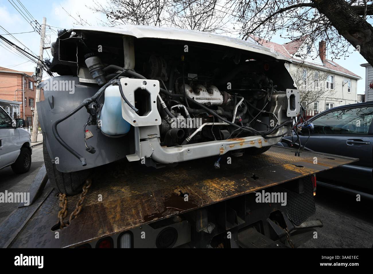 The damaged from of a minivan sits on the back of a tow truck, New York ...