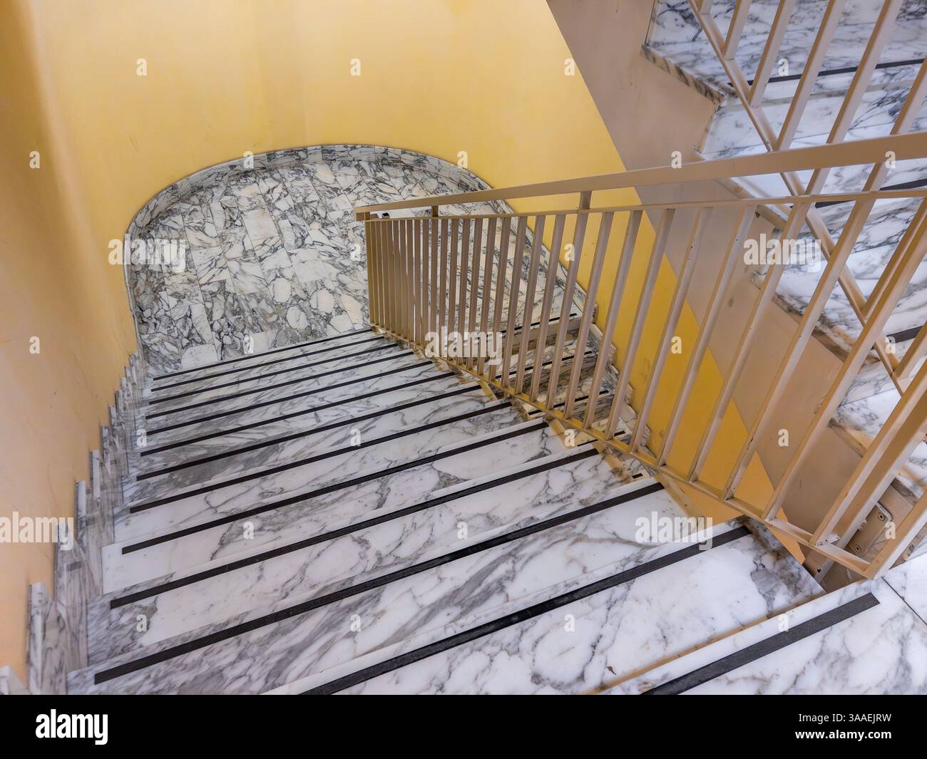 Marble staircase with curved landing and painted iron railing Stock ...