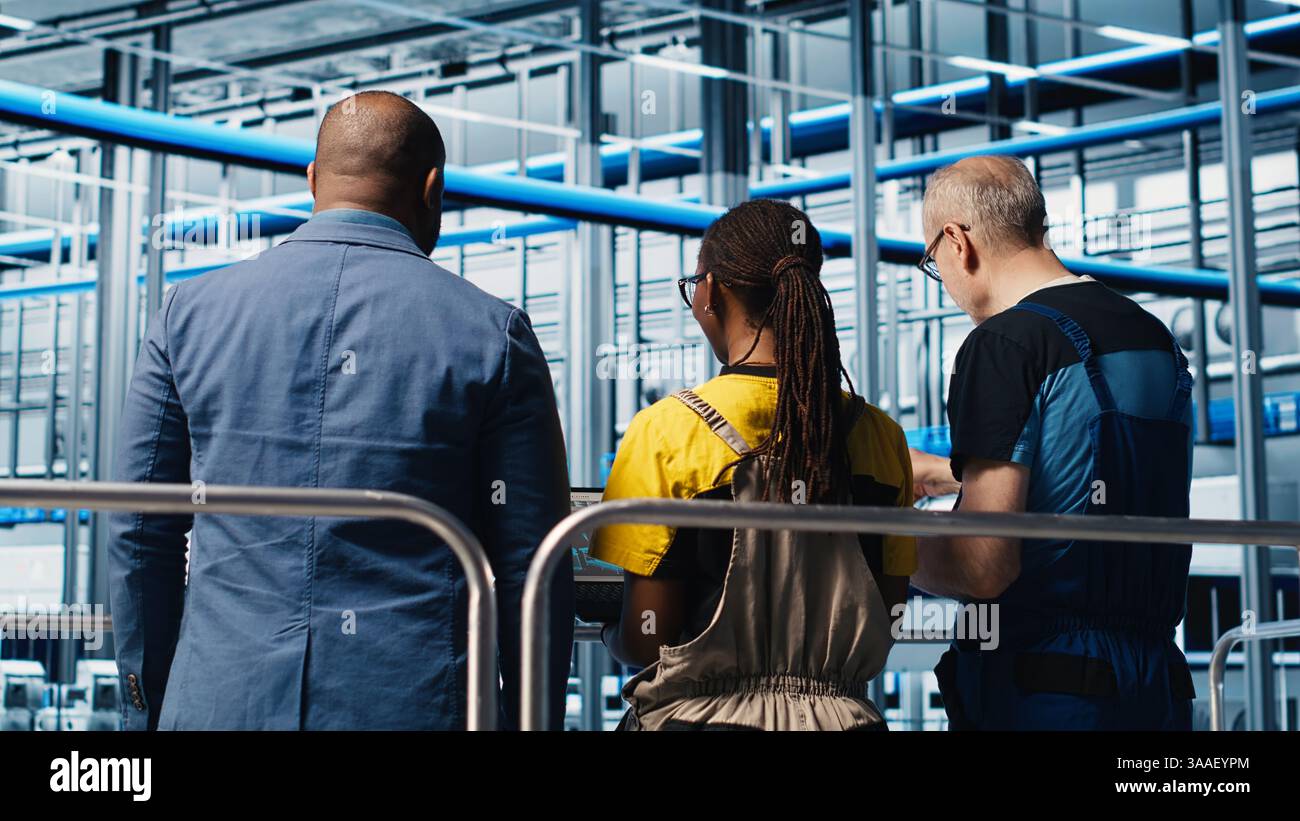 Industry 4.0 photovoltaics plant manager on industrial platform overseeing work done by ...