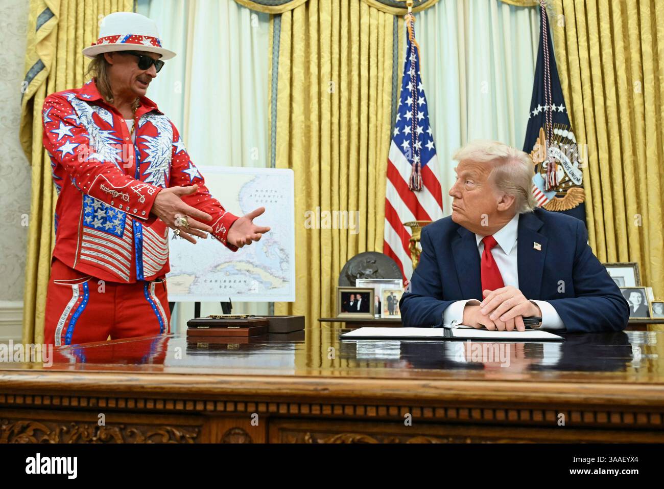 President Donald Trump listens to Kid Rock before signing an executive ...