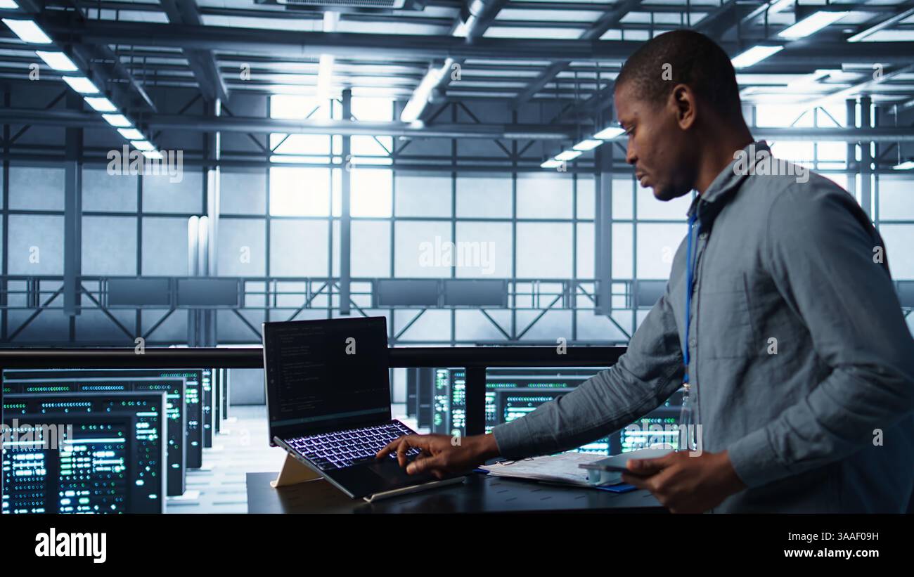 Technician in data center with laptop and tablet integrating AI driven automation tools. Server ...