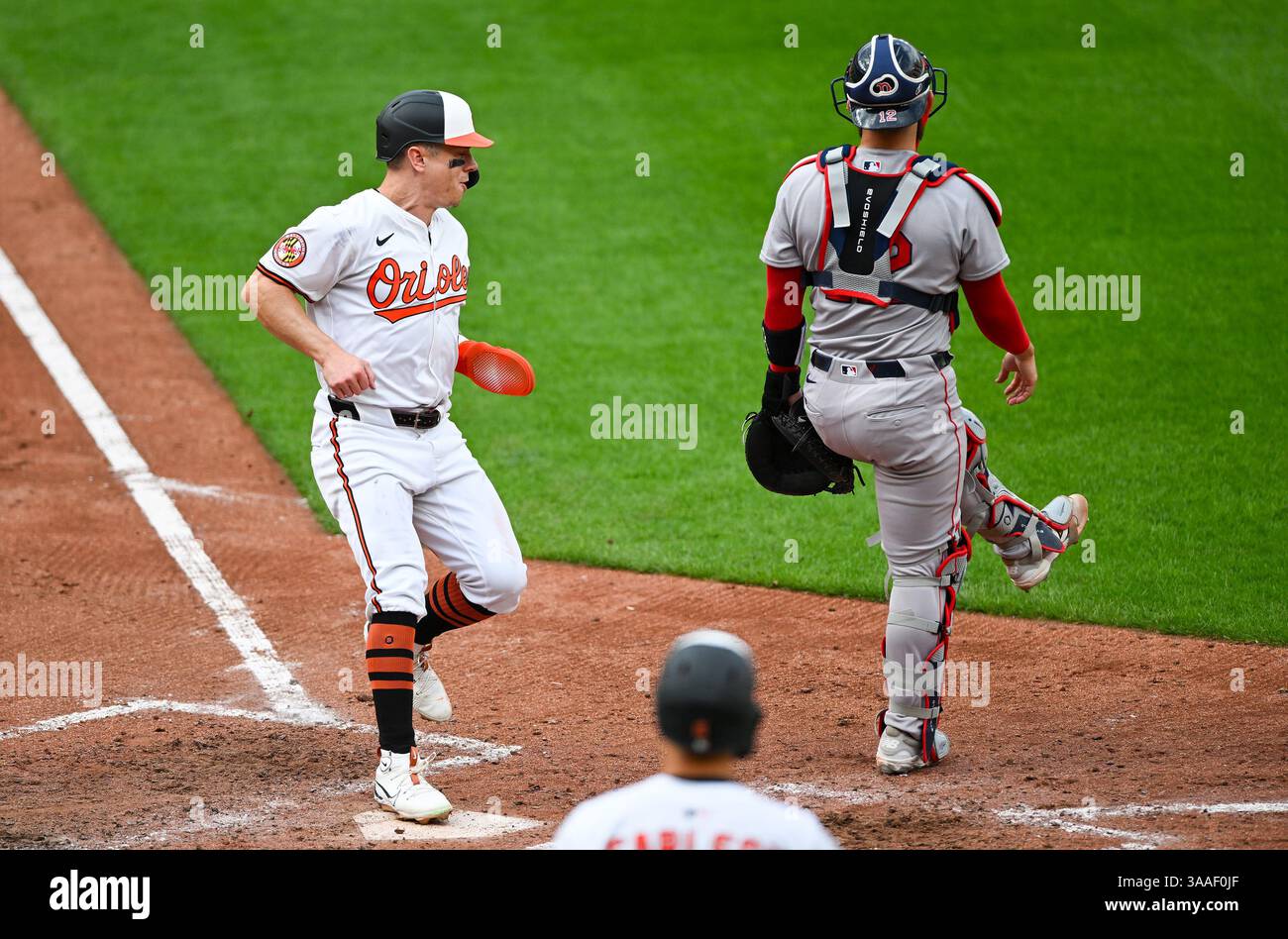 Baltimore Orioles' Tyler O'Neill (L) scores behind Boston Red Sox ...