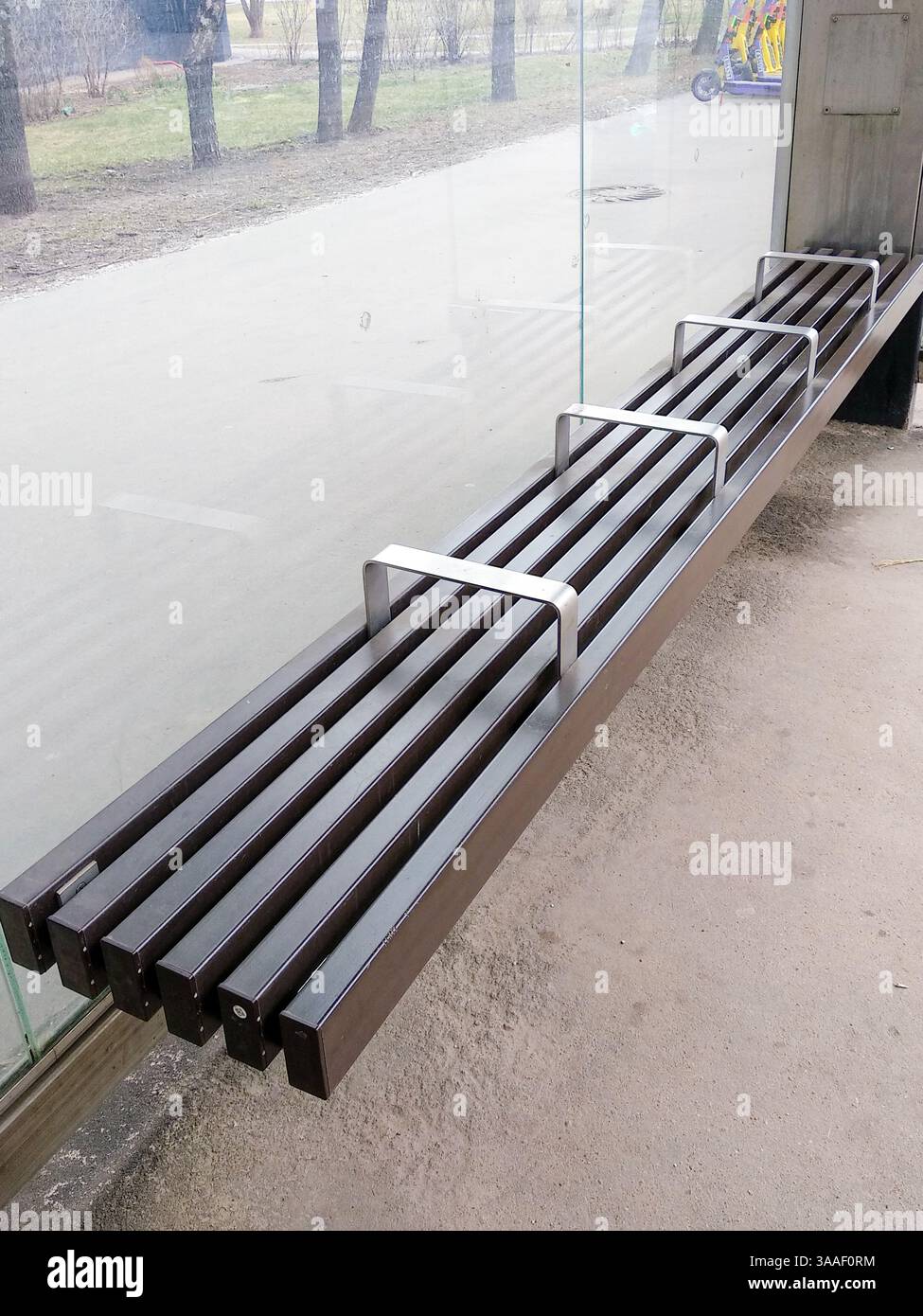 Moscow, Russia - March 30, 2025: A bench at a bus stop, reinforced with ...