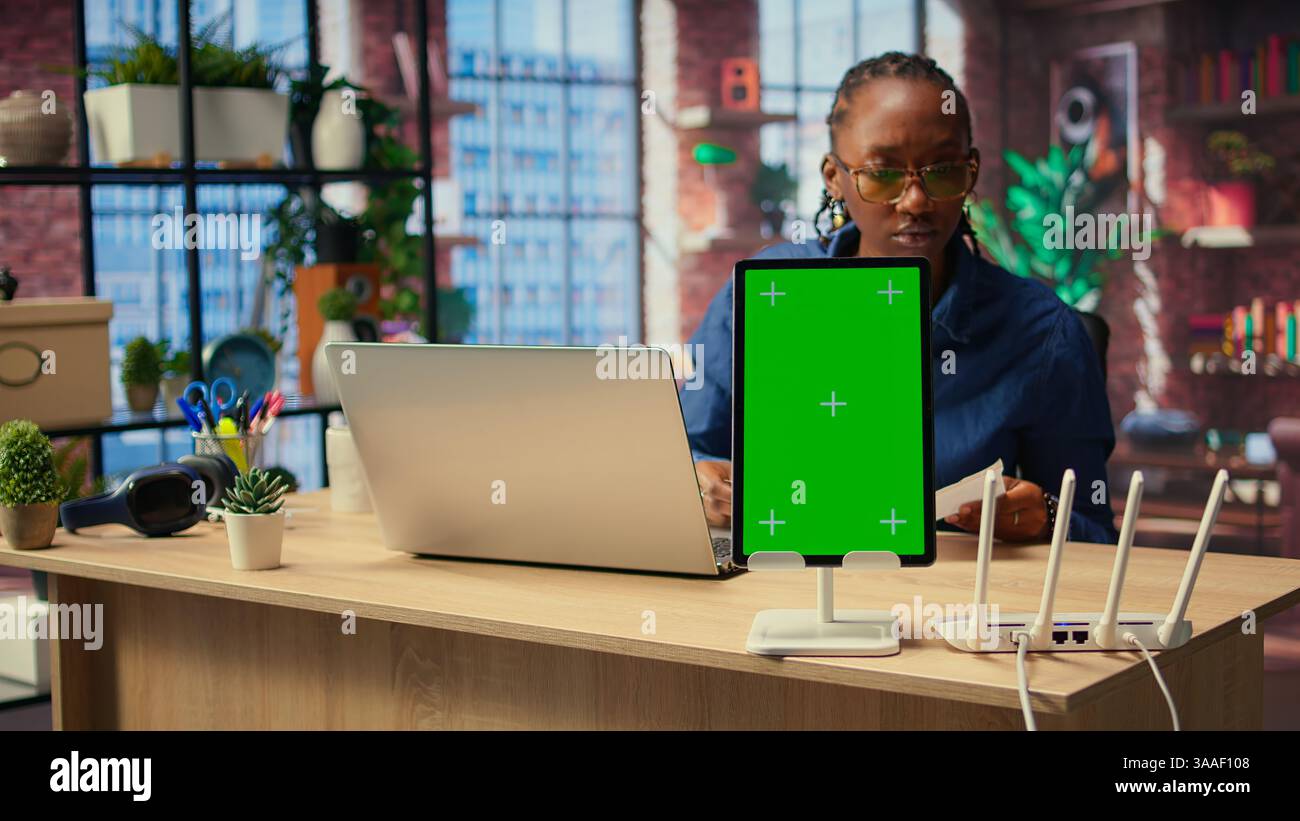 Black girl tries to fix an Wi Fi error by rebooting router next to ...