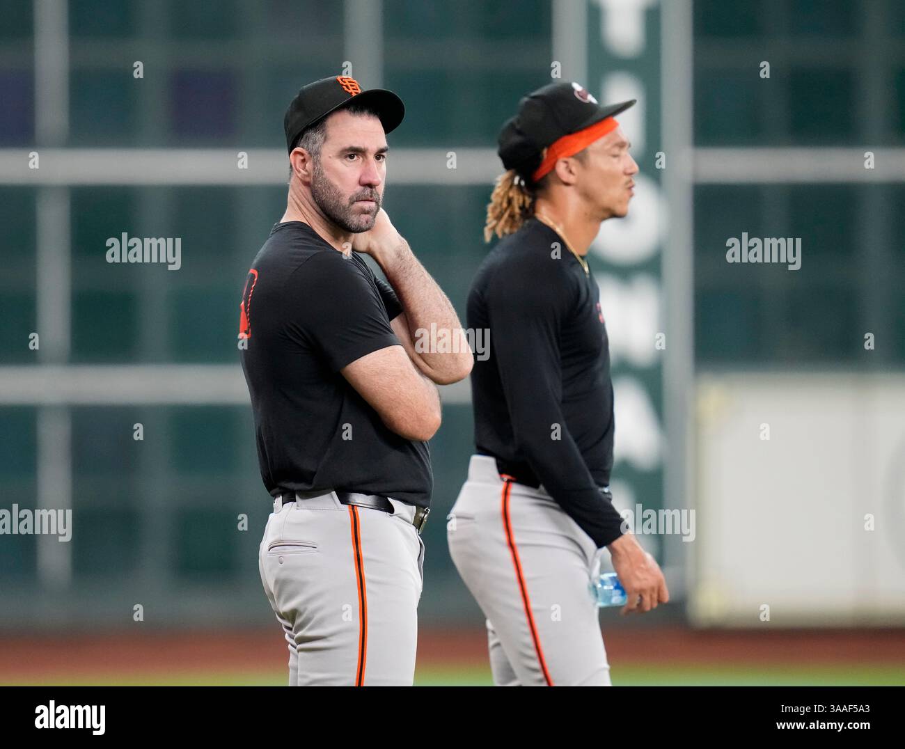 San Francisco Giants pitcher Justin Verlander, left, looks on during ...