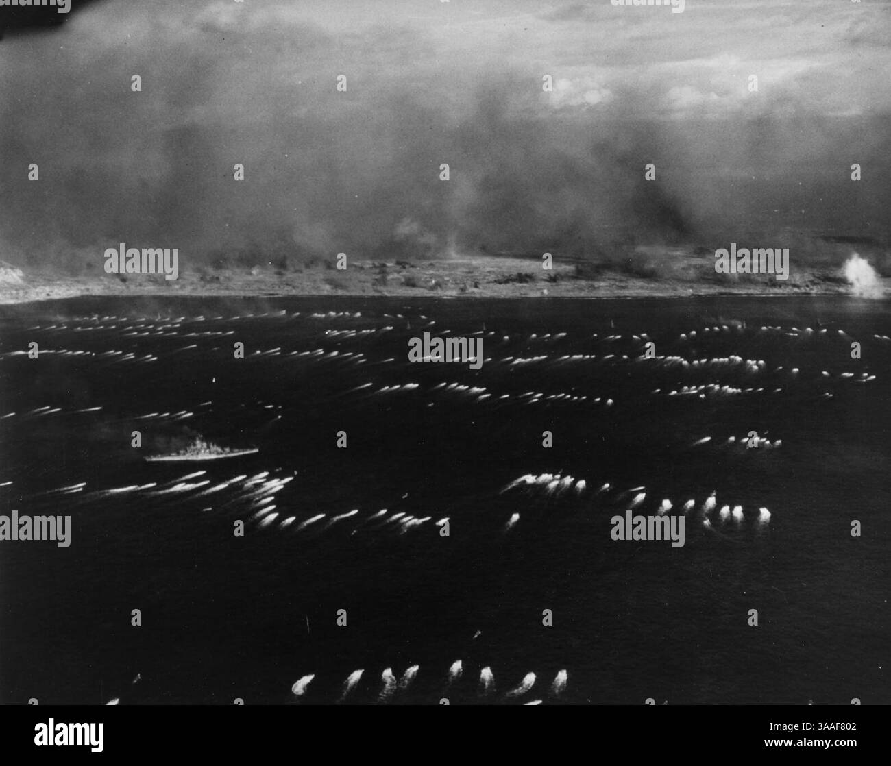Initial waves of amphibious tractors head for the landing beaches on ...