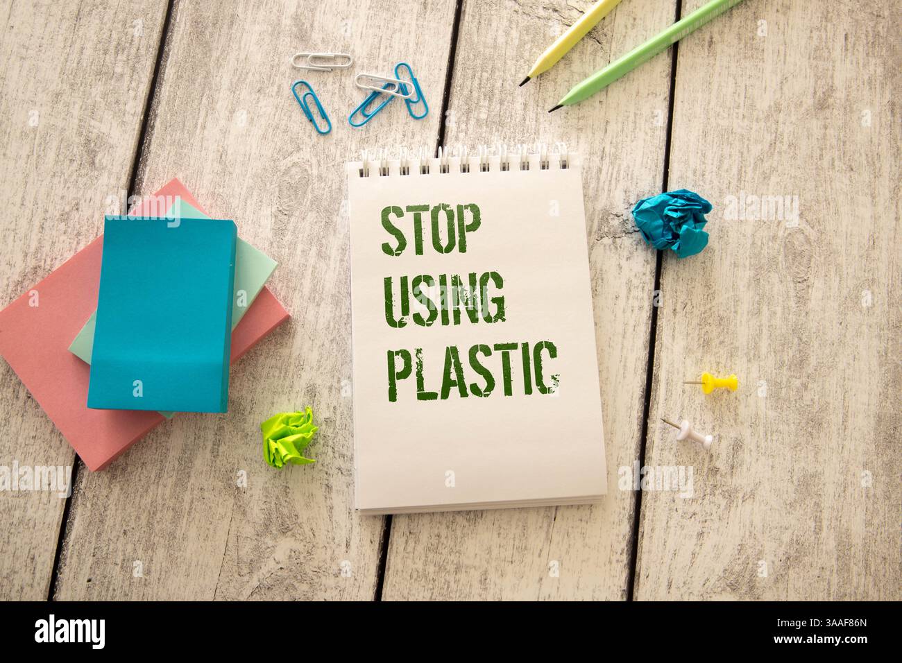 Woman hand holding brown paper bag on green background. Stop using ...