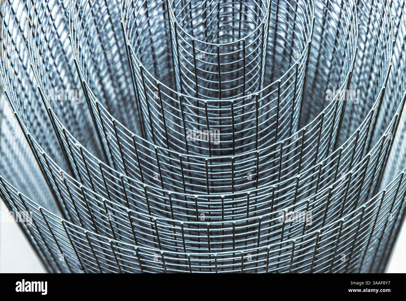 Abstract spiral metal coiled wire mesh with grid pattern, geometric ...
