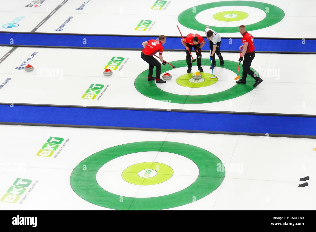 Scotland skip Bruce Mouat sweeps a Scottish stone in the button as ...