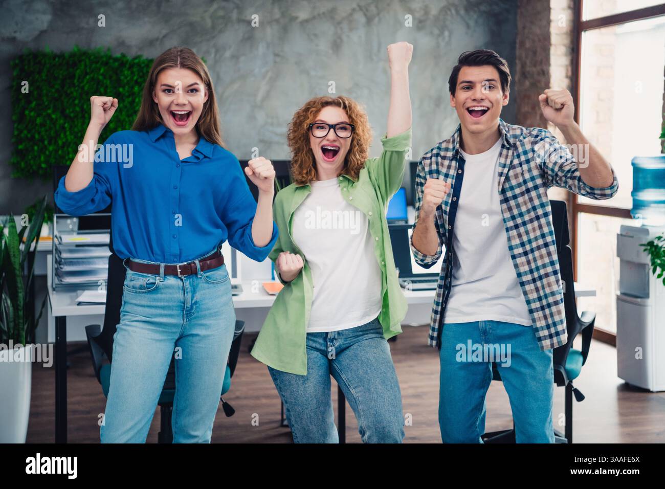 Group of young professionals celebrating success with expressions of ...