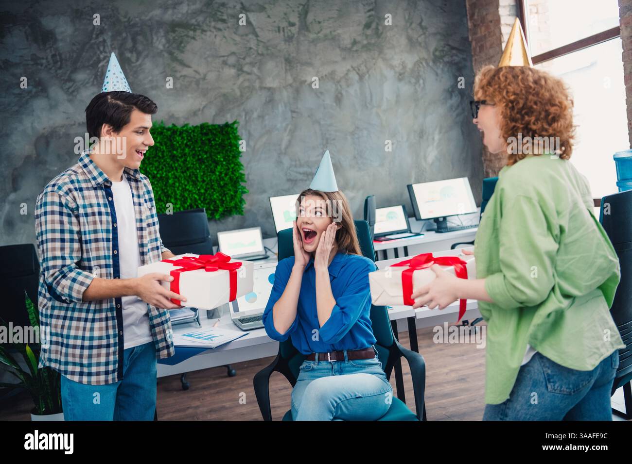 Group of young colleagues celebrating a birthday in a modern office ...