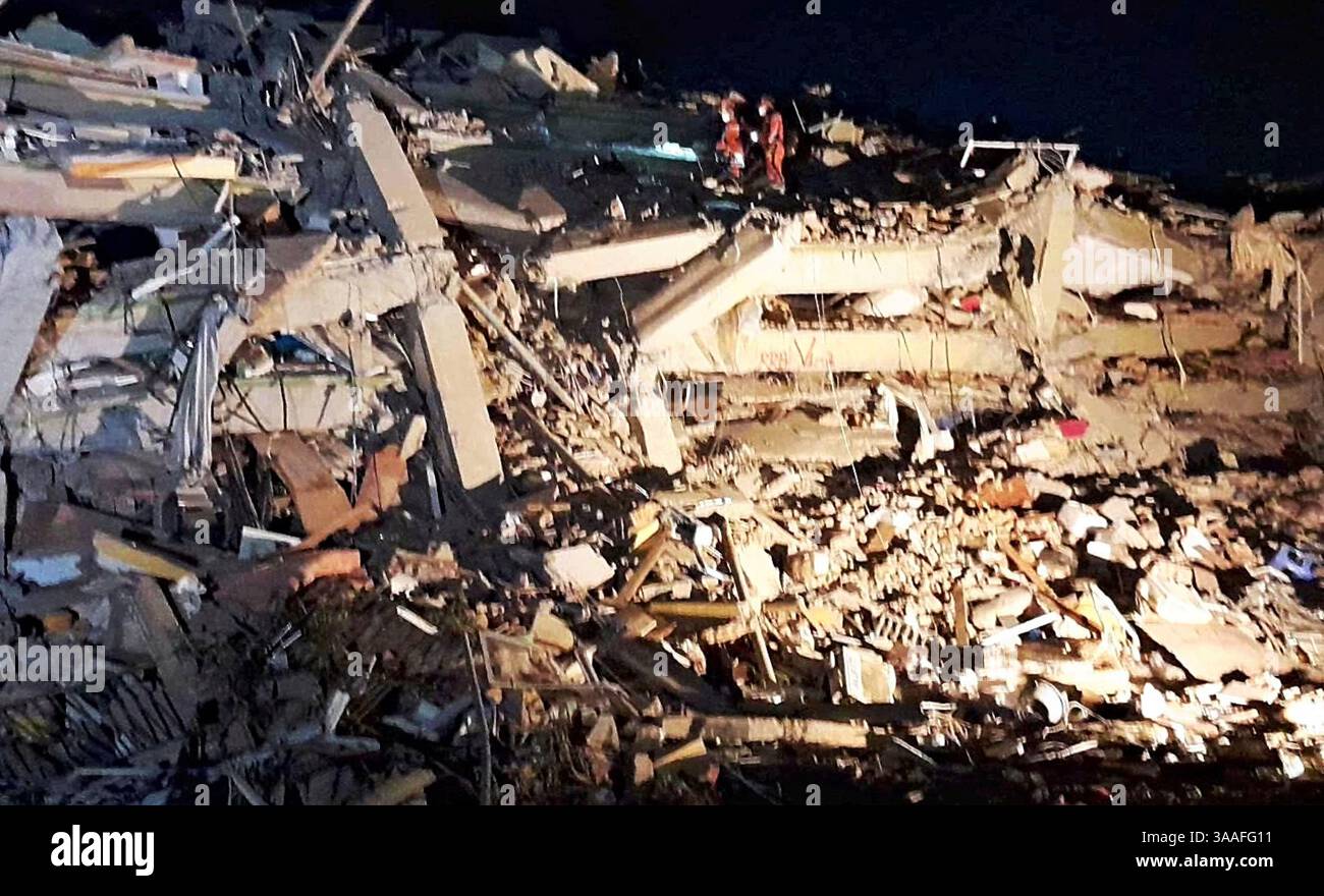 A photo shows an apartment building collapsed due to an earthquake in ...