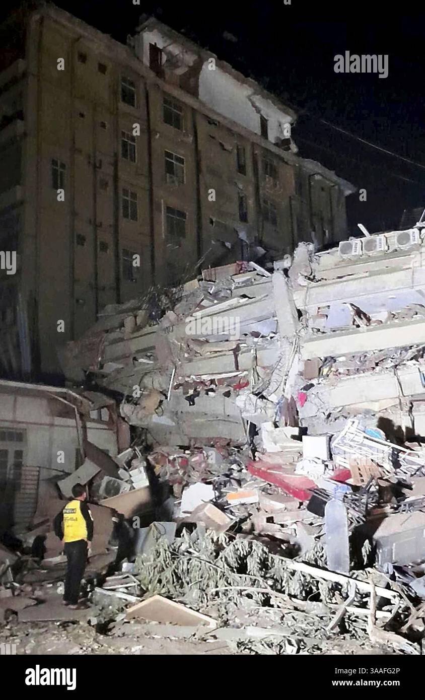 A photo shows an apartment building collapsed due to an earthquake in ...