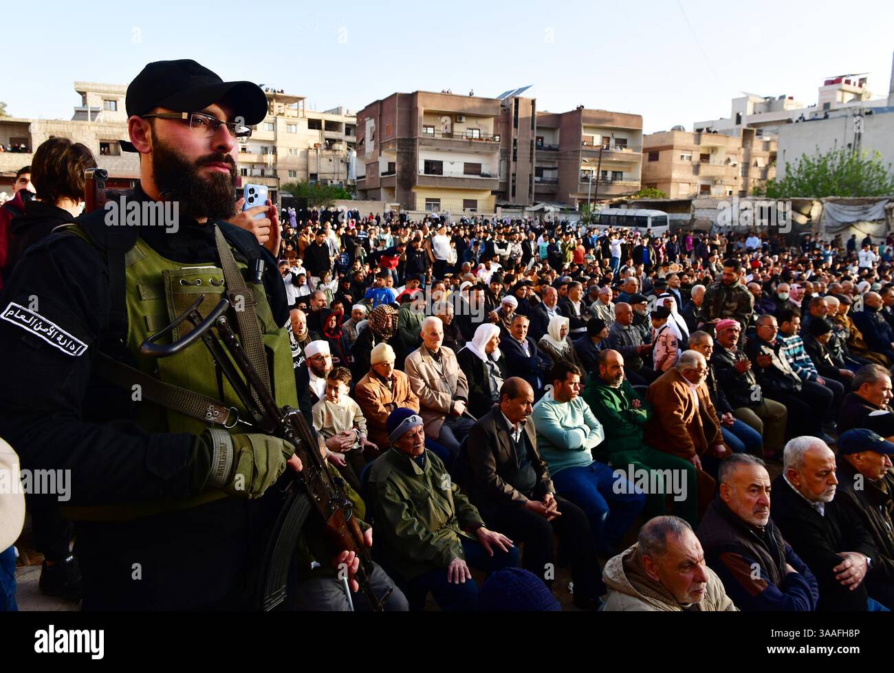 Damascus, Syria. 31st Mar, 2025. A security guard stands ready as ...