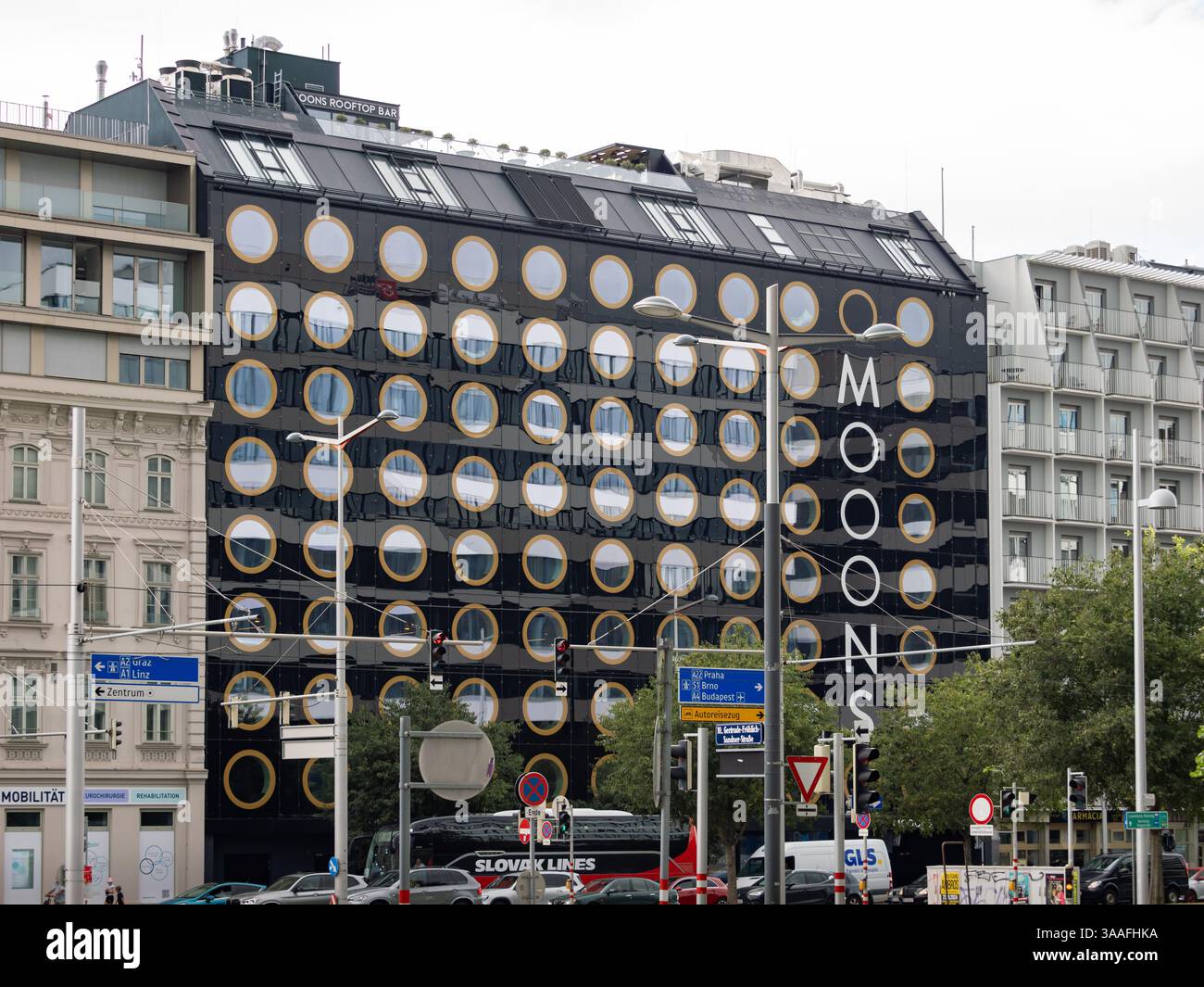 MOOONS design hotel building exterior. Black facade with round windows ...