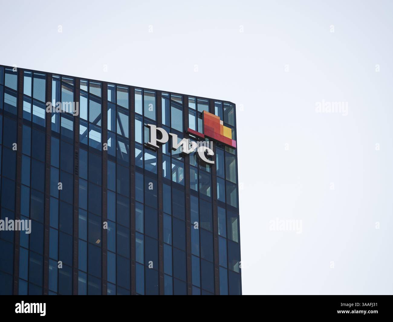PwC logo on a skyscraper office building. PricewaterhouseCoopers sign ...