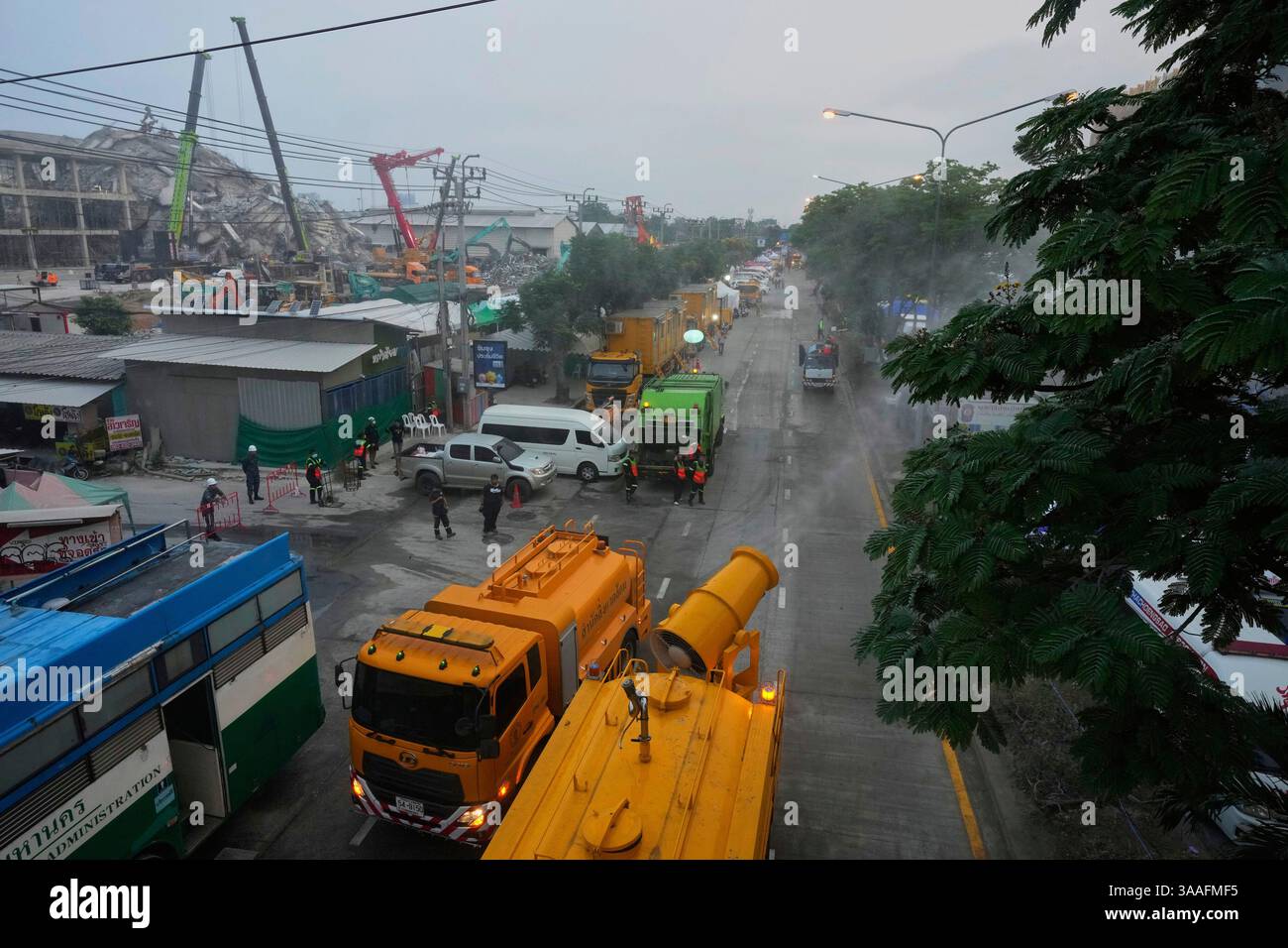 Authorities clean the area around an under-construction high-rise ...