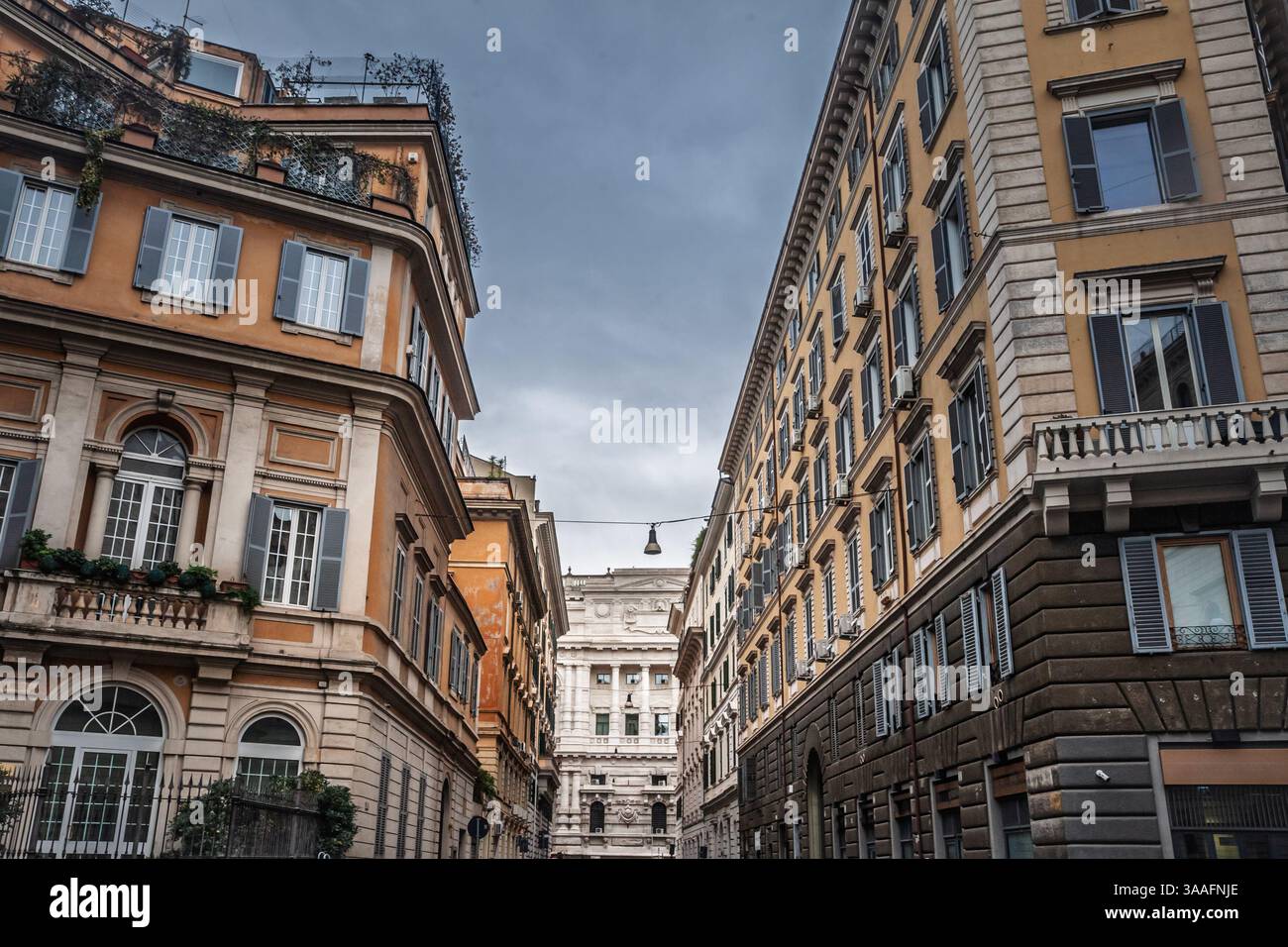 View down a street lined with traditional residential buildings in Rome ...