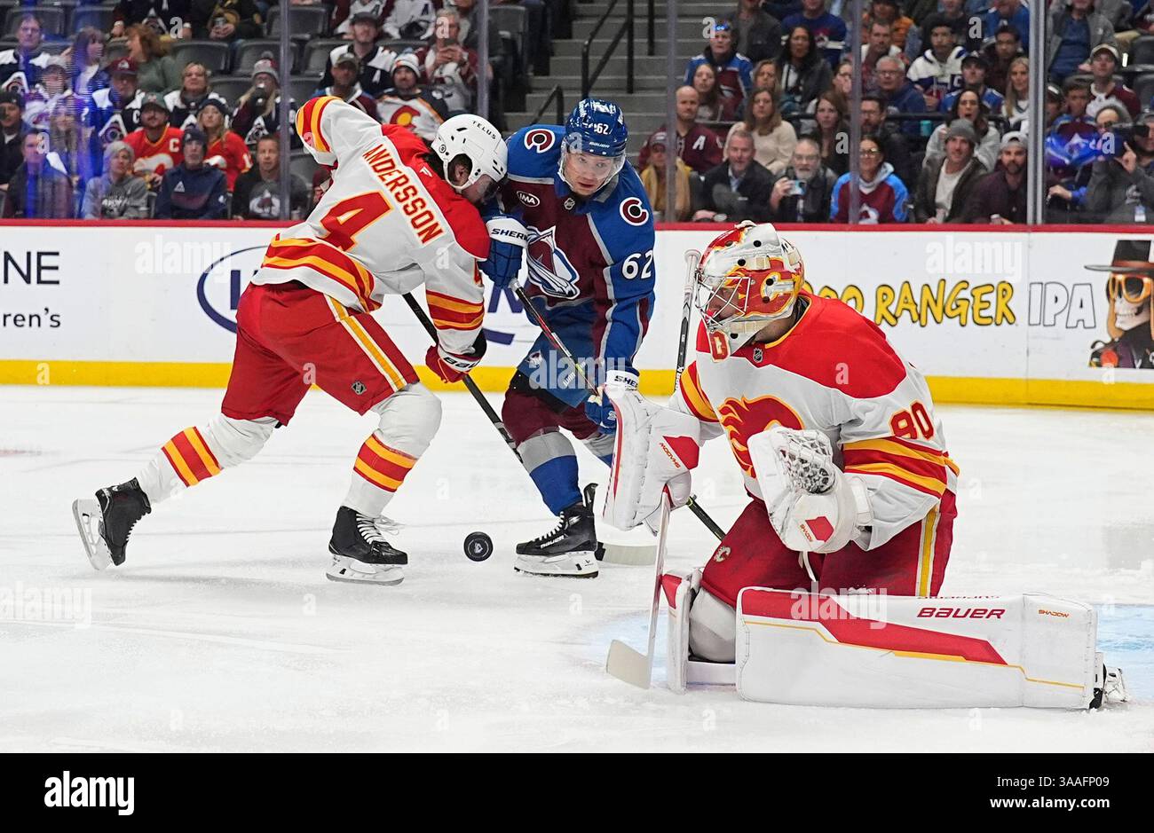 Calgary Flames goaltender Dan Vladar, front, stops a shot as Calgary ...