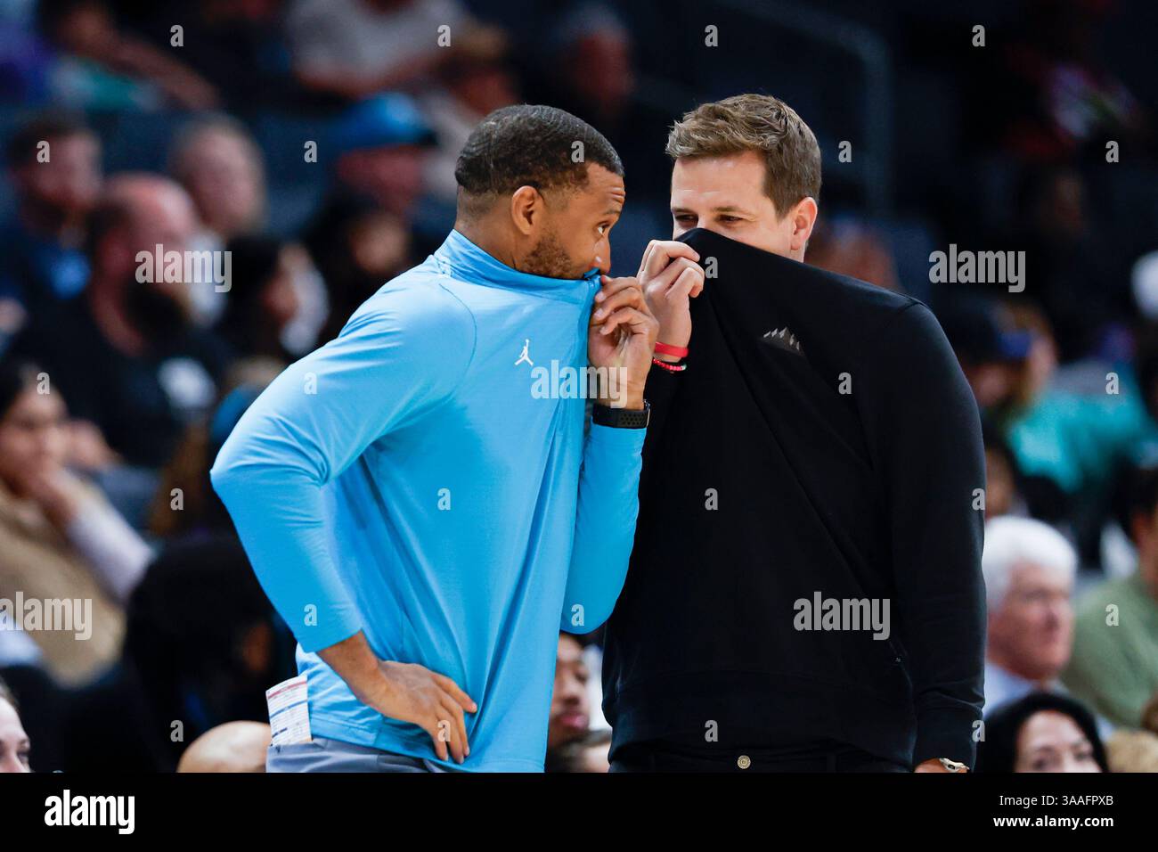 Utah Jazz head coach Will Hardy, right, talks to Charlotte Hornets head coach Charles Lee, right ...