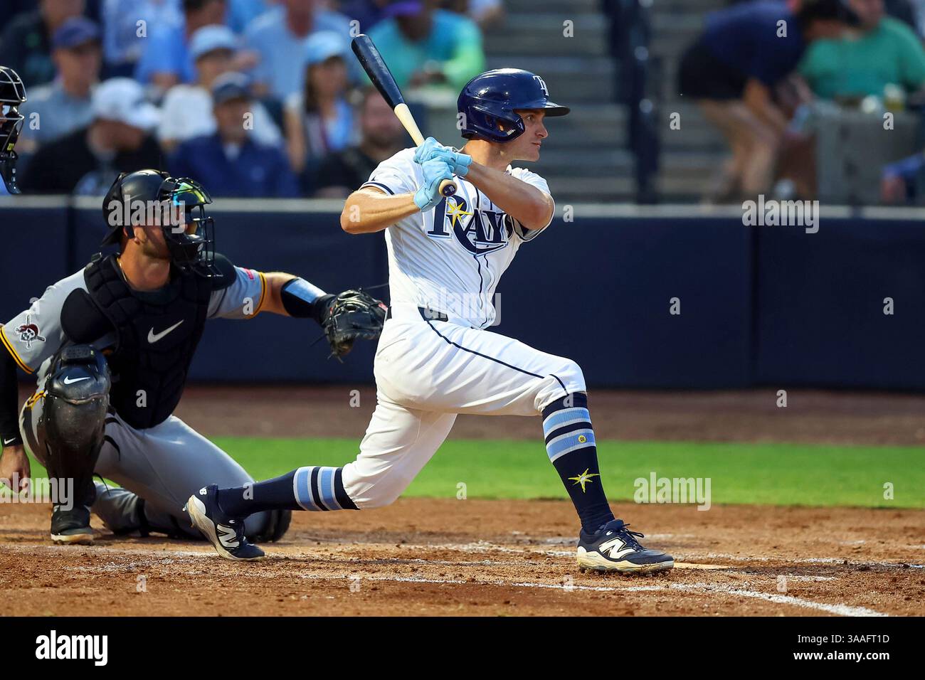 Tampa Bay Rays' Jake Mangum, right, follows through on his first major ...