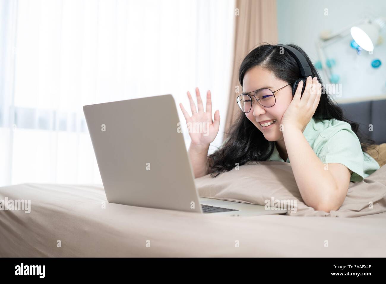 Beautiful Asian woman using zoom meeting and making facetime video ...