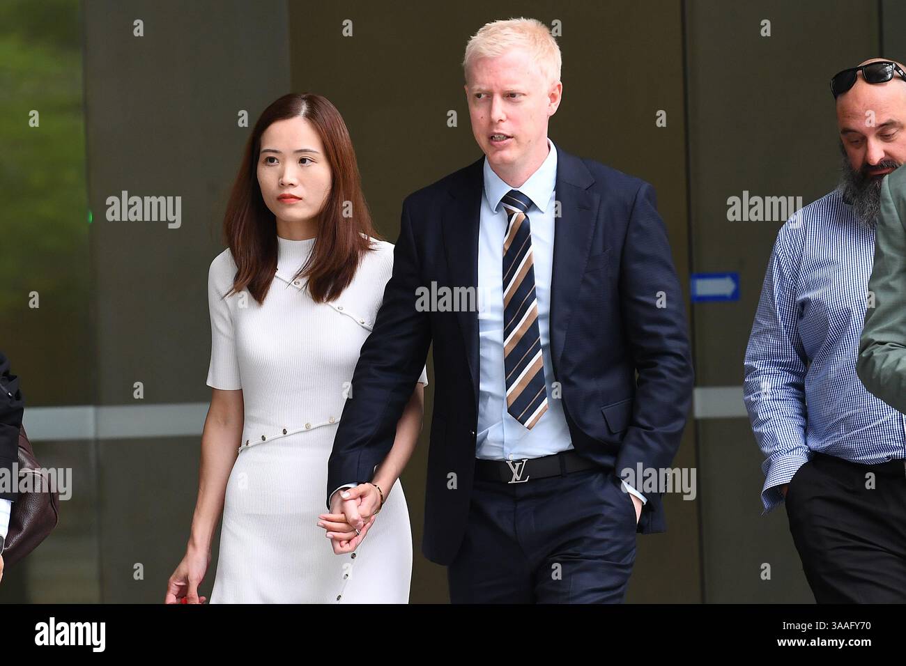 Karl Jobst (middle) leaves the Brisbane District Court, in Brisbane ...