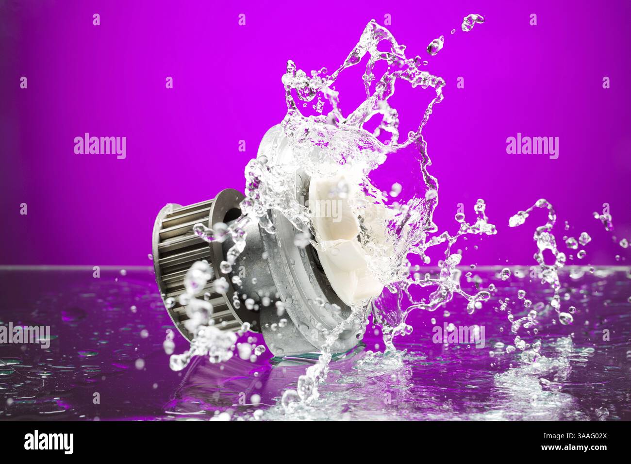 Auto parts, engine cooling pump in spurts of water on purple gradient ...