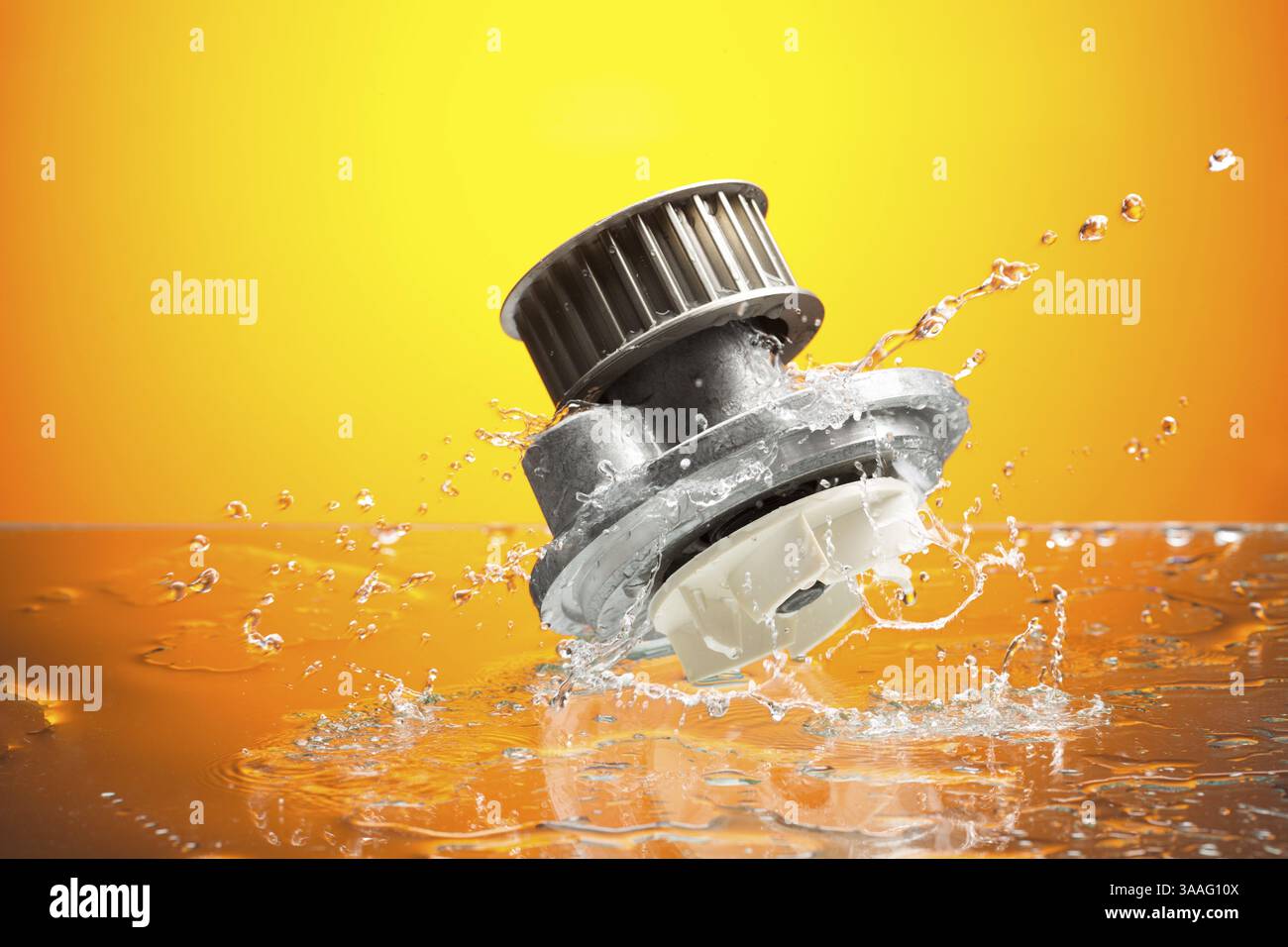 Auto parts, engine cooling pump in water splash on orange gradient ...