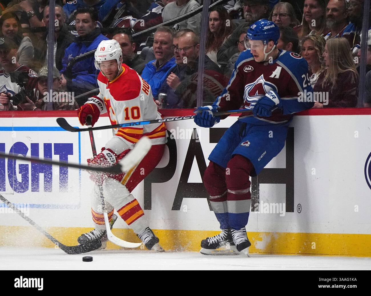 Calgary Flames left wing Jonathan Huberdeau, left, pursues the puck ...