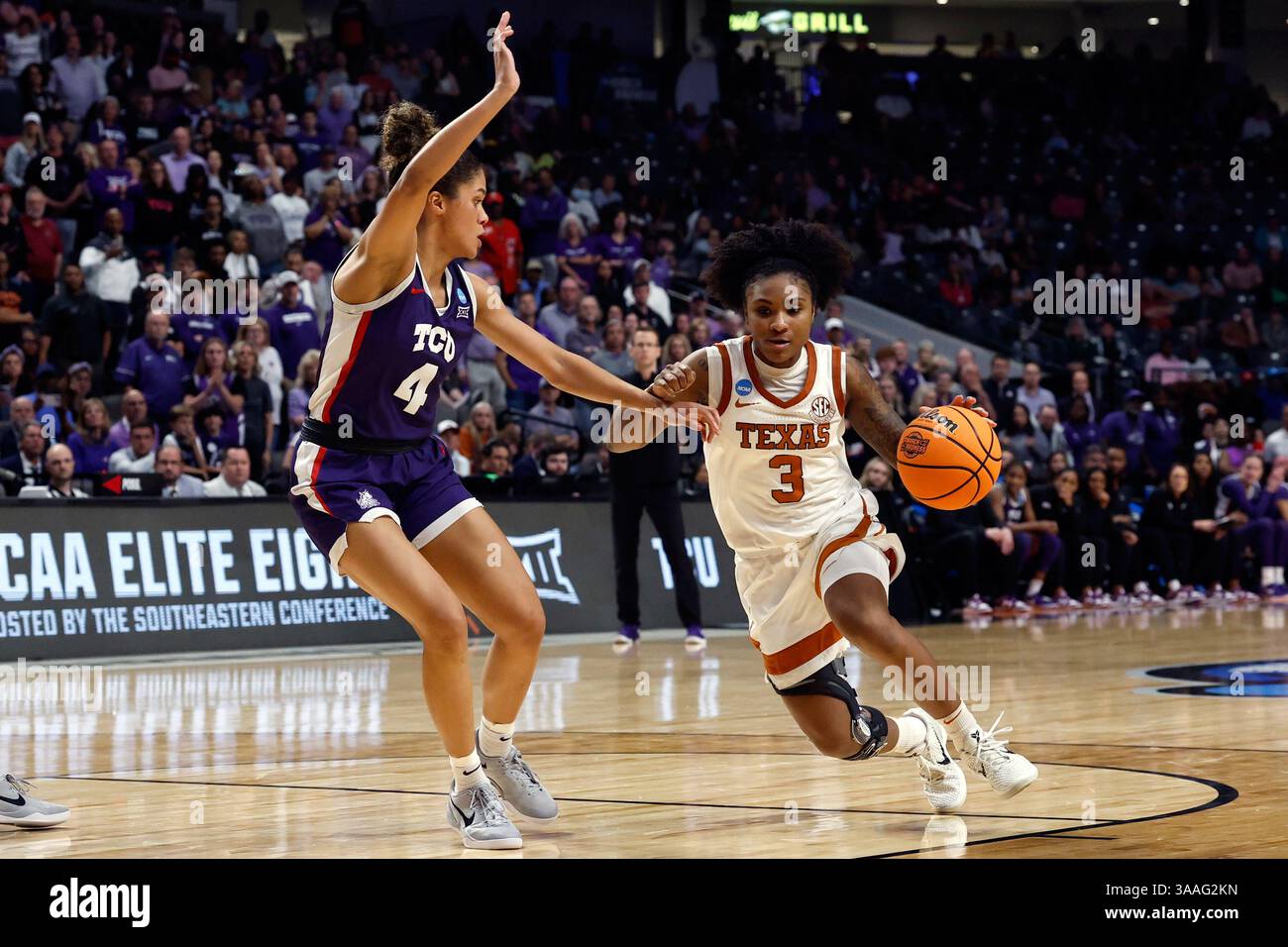 Texas guard Rori Harmon (3) drives to the basket around TCU guard ...