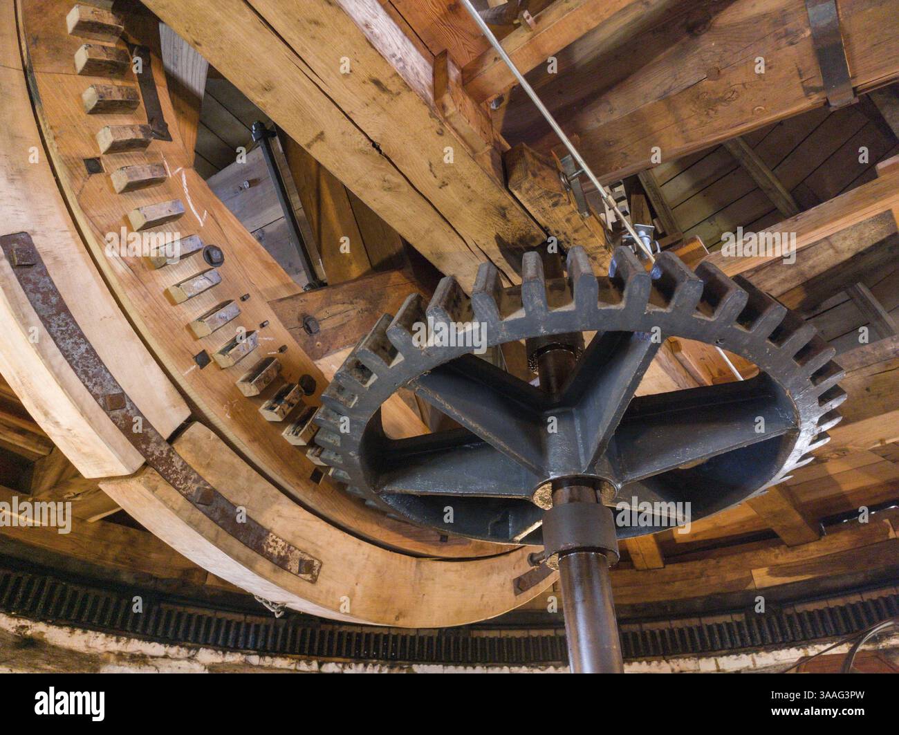 Large cogwheels within an old wooden structure, industrial mechanics ...
