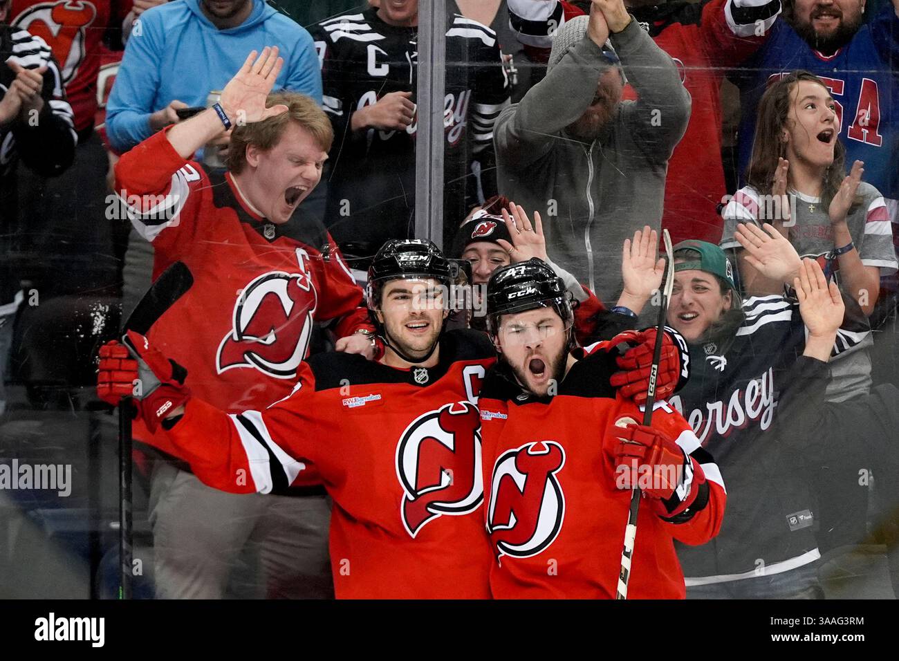 New Jersey Devils center Paul Cotter (47), right, celebrates his goal ...
