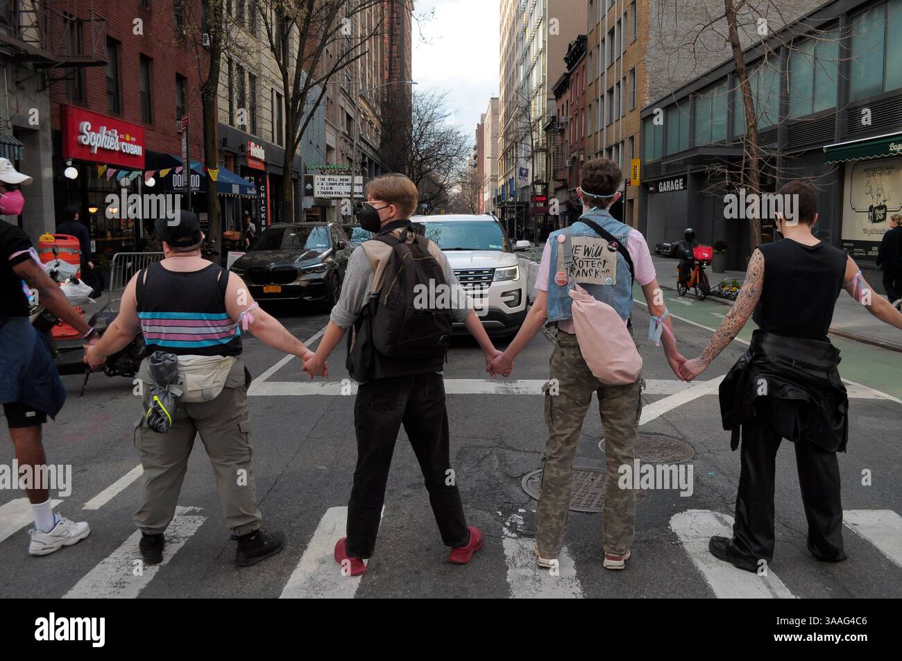 New York, United States. 31st Mar, 2025. Demonstrators lock hands to ...