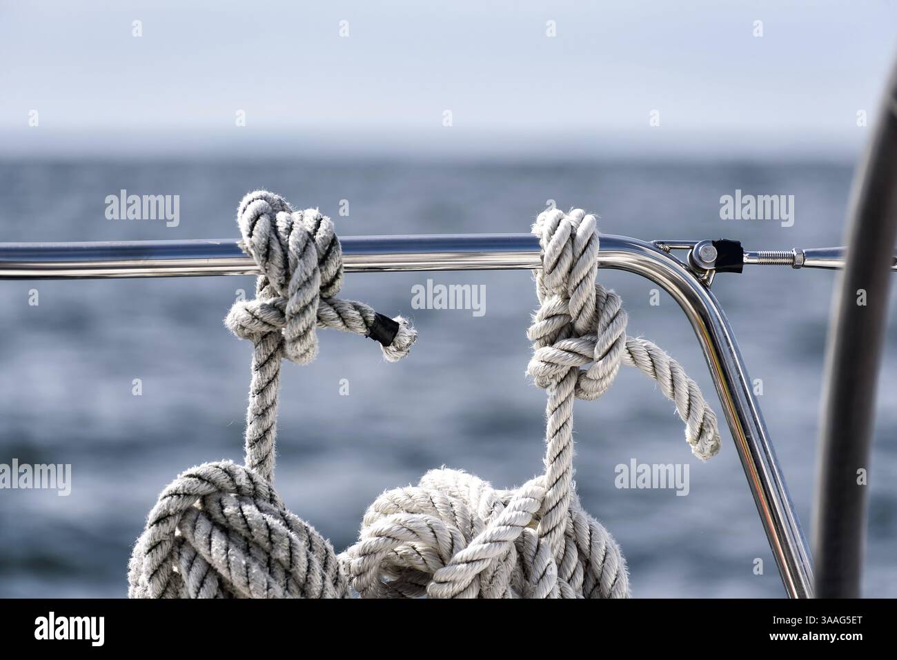 Mooring line on a sailing yacht at sea hanging from the railing Stock ...