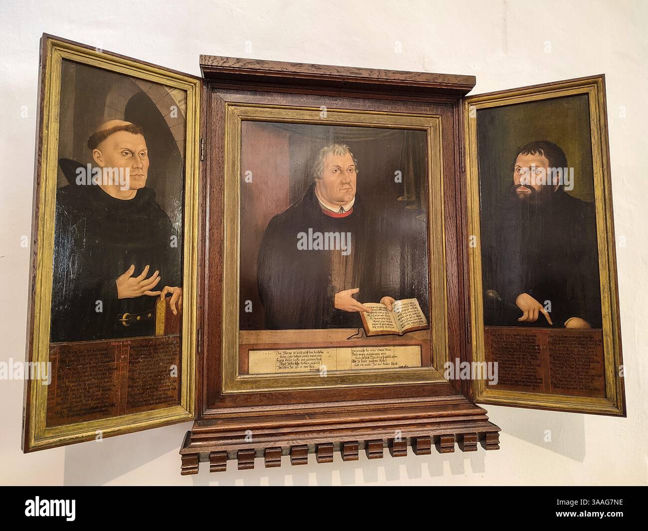 Religious altarpiece with three portraits of the reformer Martin Luther ...