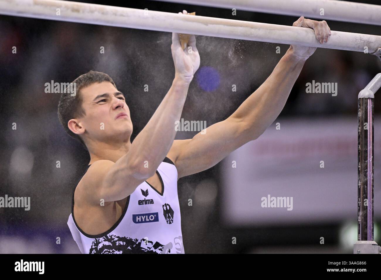 Timo Eder GER prepares parallel bars with magnesia Gymnastics, EnBW DTB ...