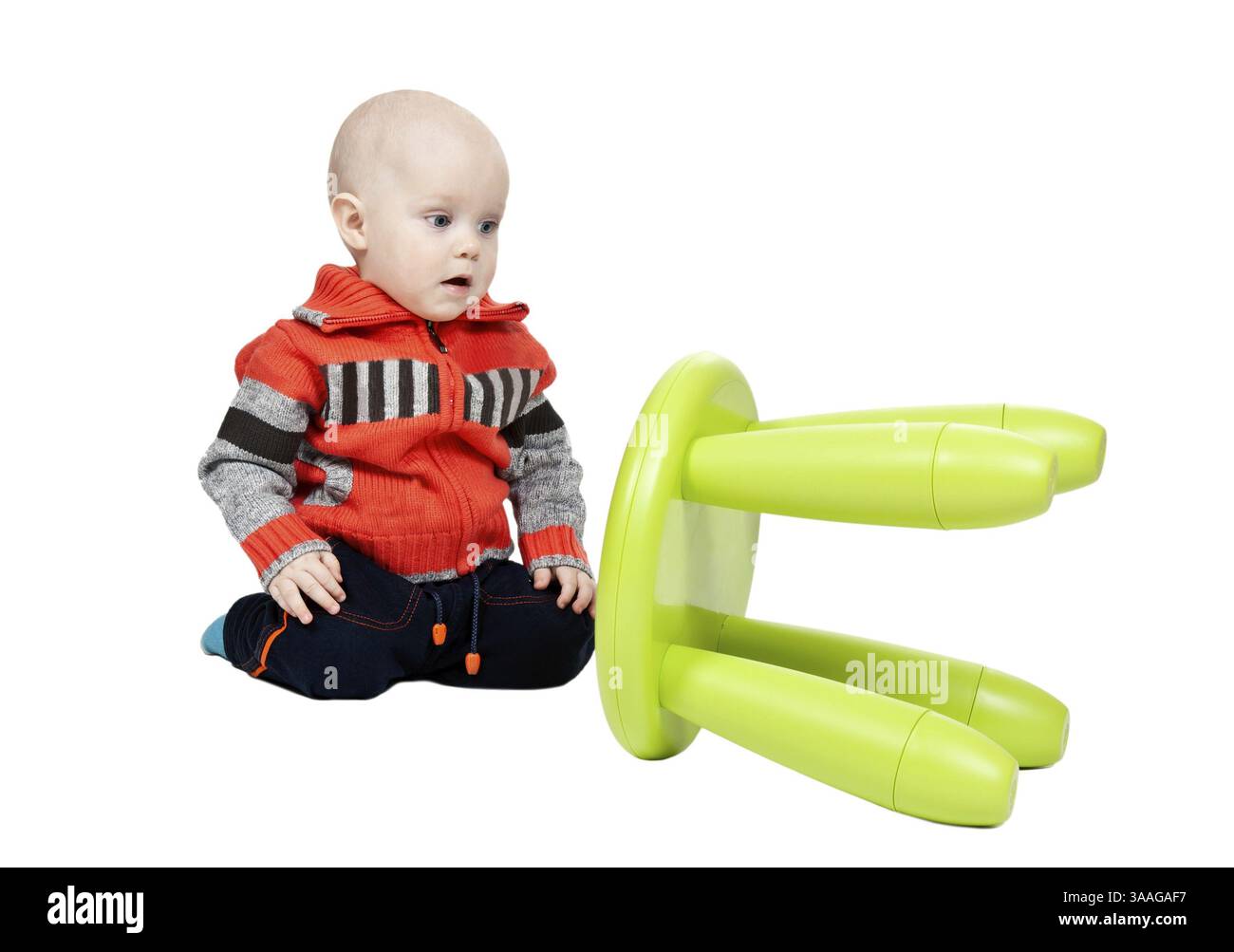 Child dropped a plastic chair in the studio on a white background Stock ...