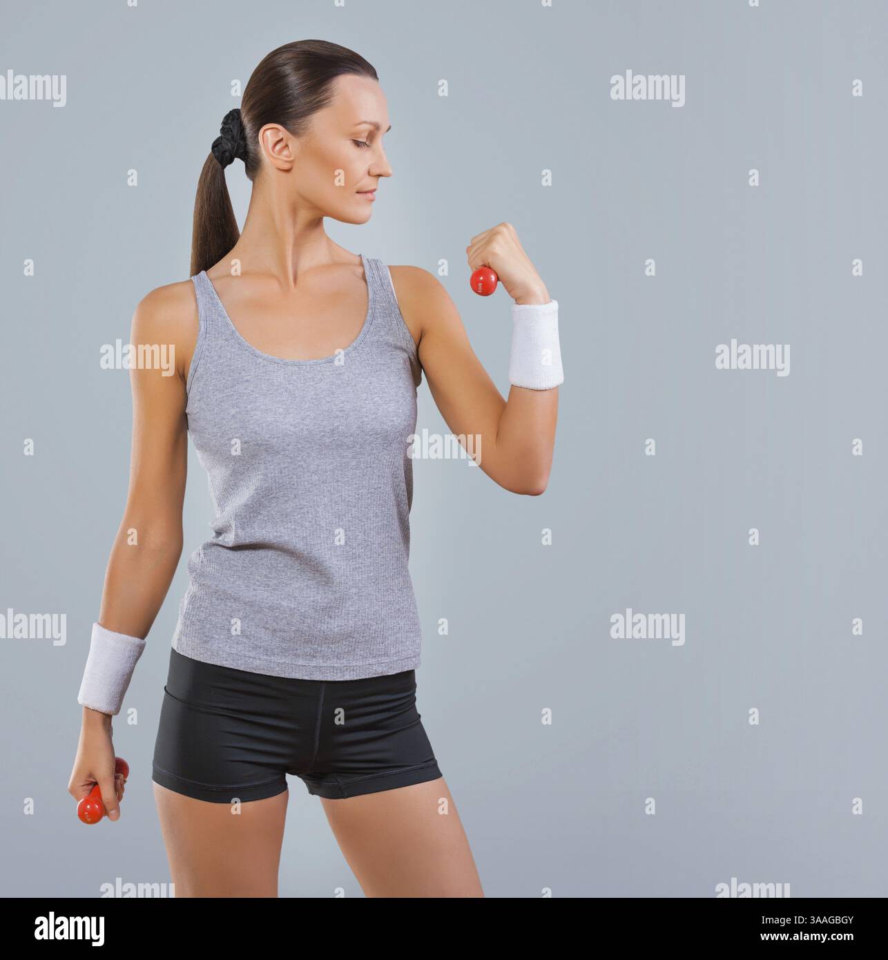 A sportswoman holding small weights Stock Photo - Alamy