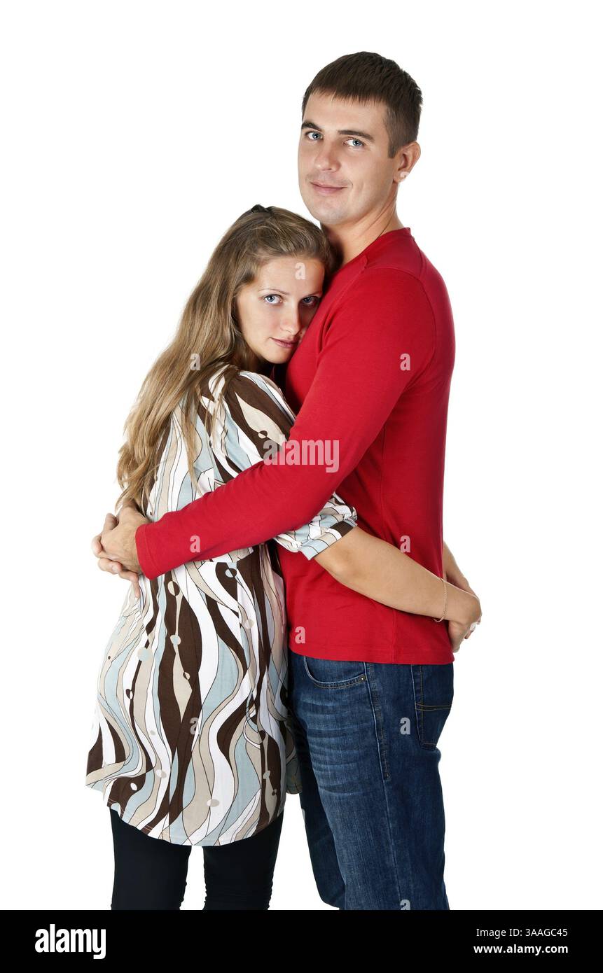 Girl hugging a guy in a red dress in the studio on a white background ...