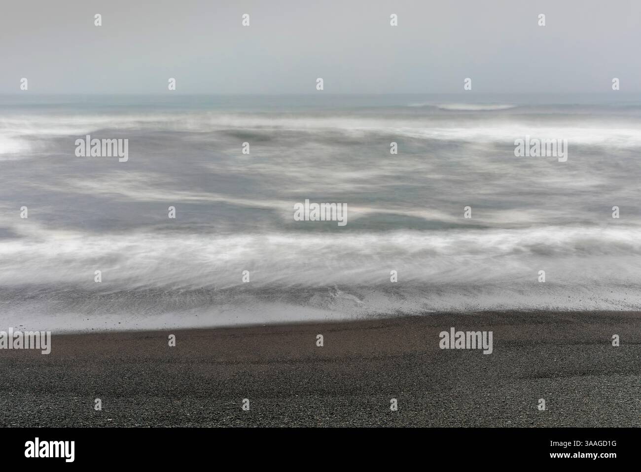 Long exposure of Pacific Ocean surf lapping up on Gold Bluffs Beach ...