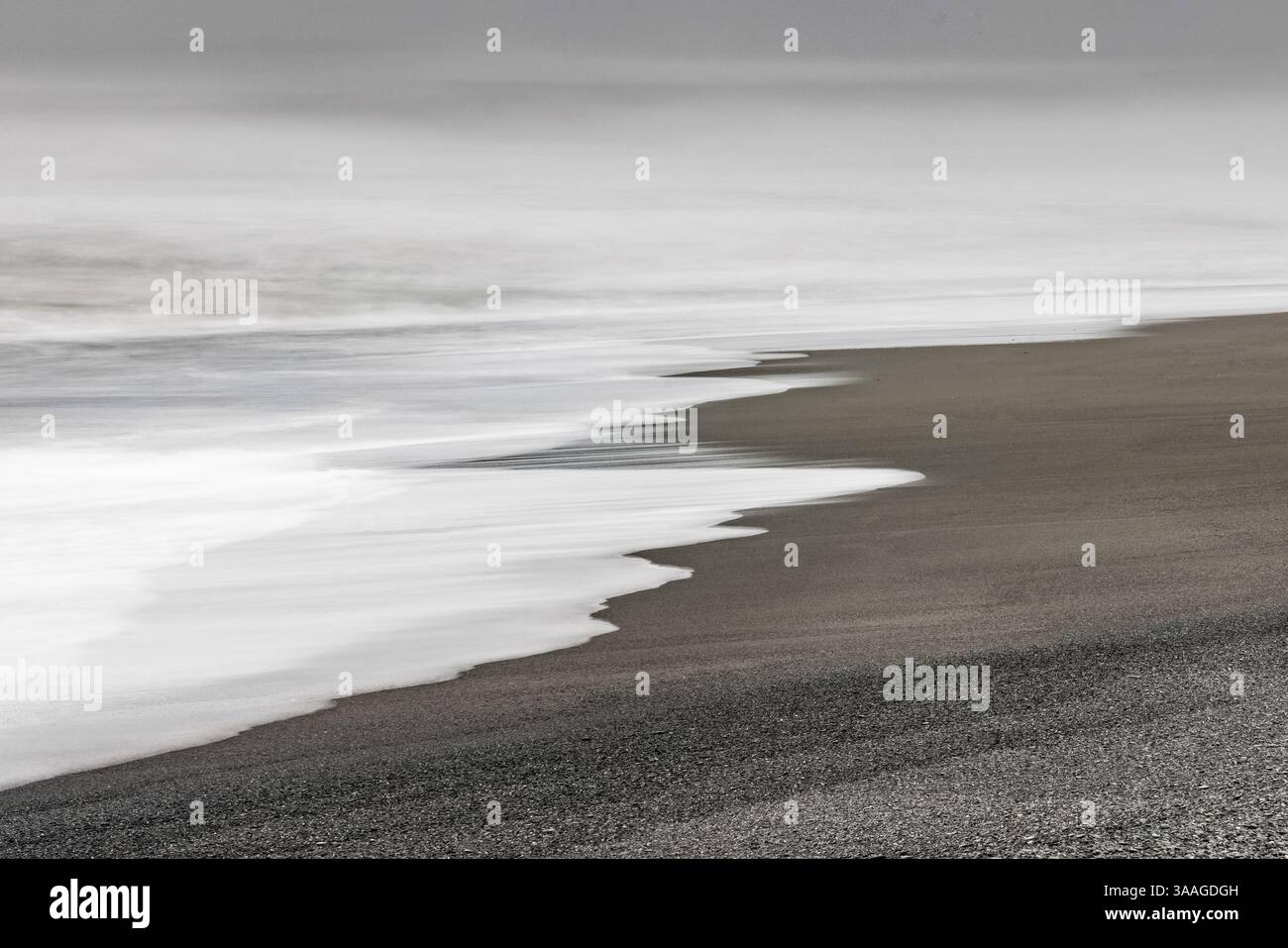 Long exposure of Pacific Ocean surf lapping up on Gold Bluffs Beach ...