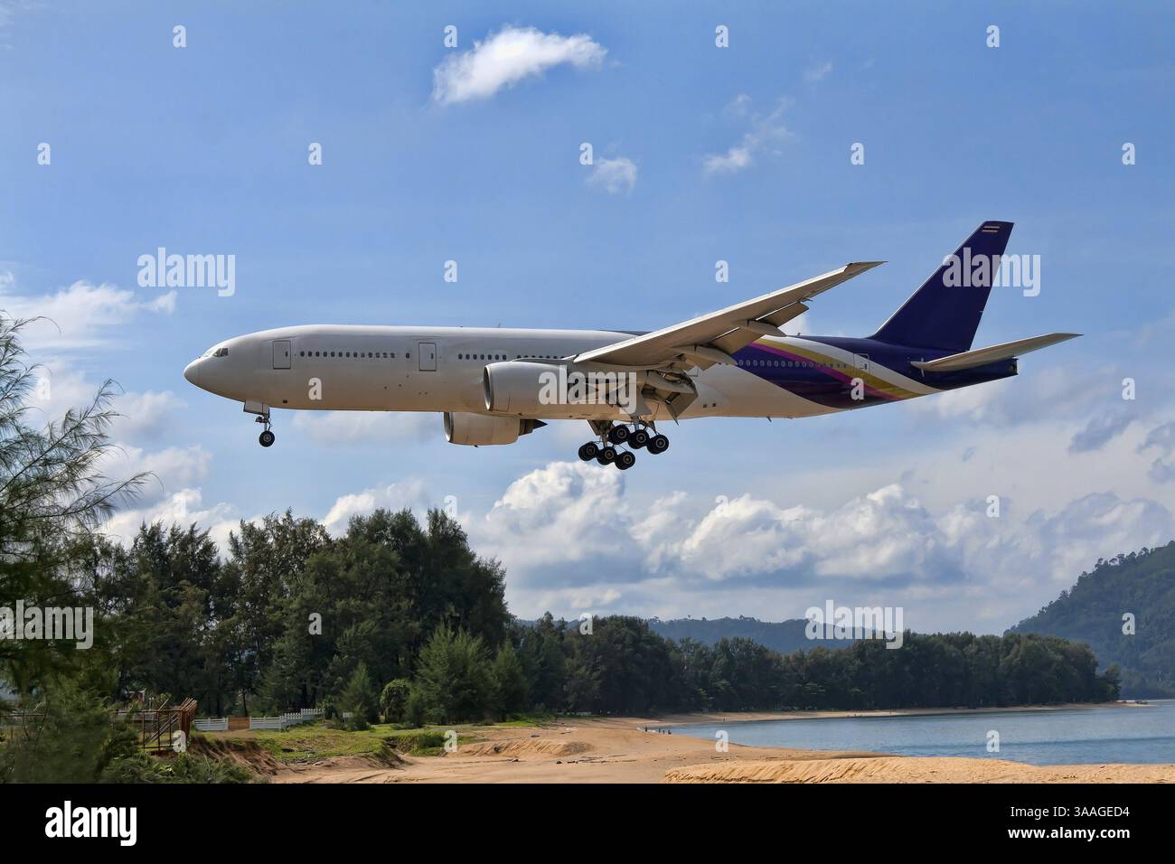 Passenger aircraft over the beach in Phuket Stock Photo - Alamy