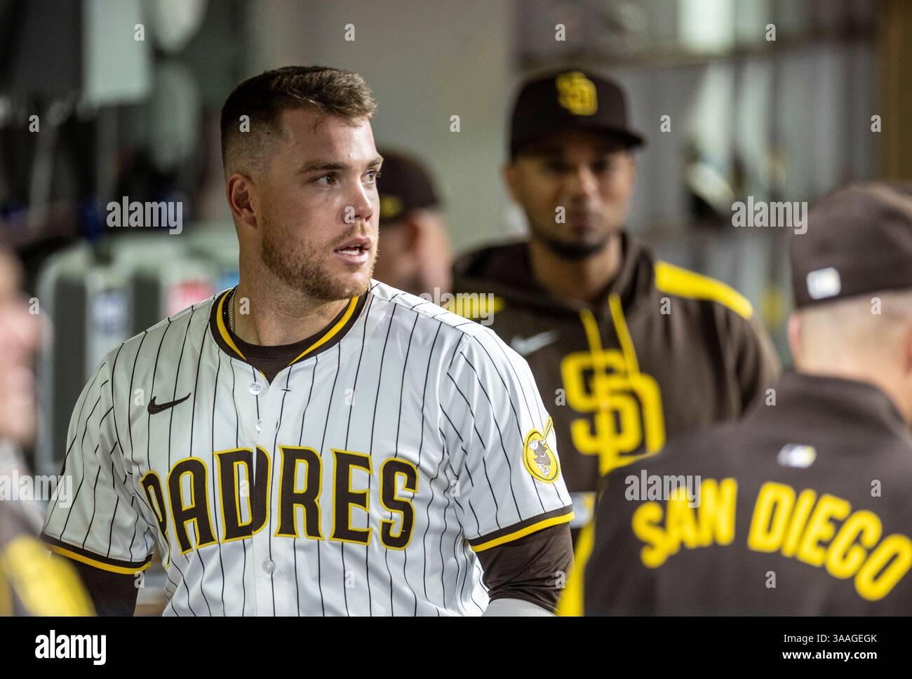 San Diego Padres' Gavin Sheets, left, looks from the dugout after ...