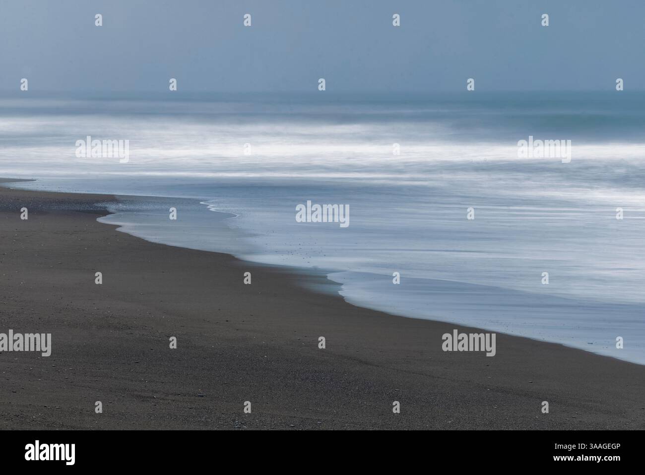 Long exposure of Pacific Ocean surf lapping up on Gold Bluffs Beach ...
