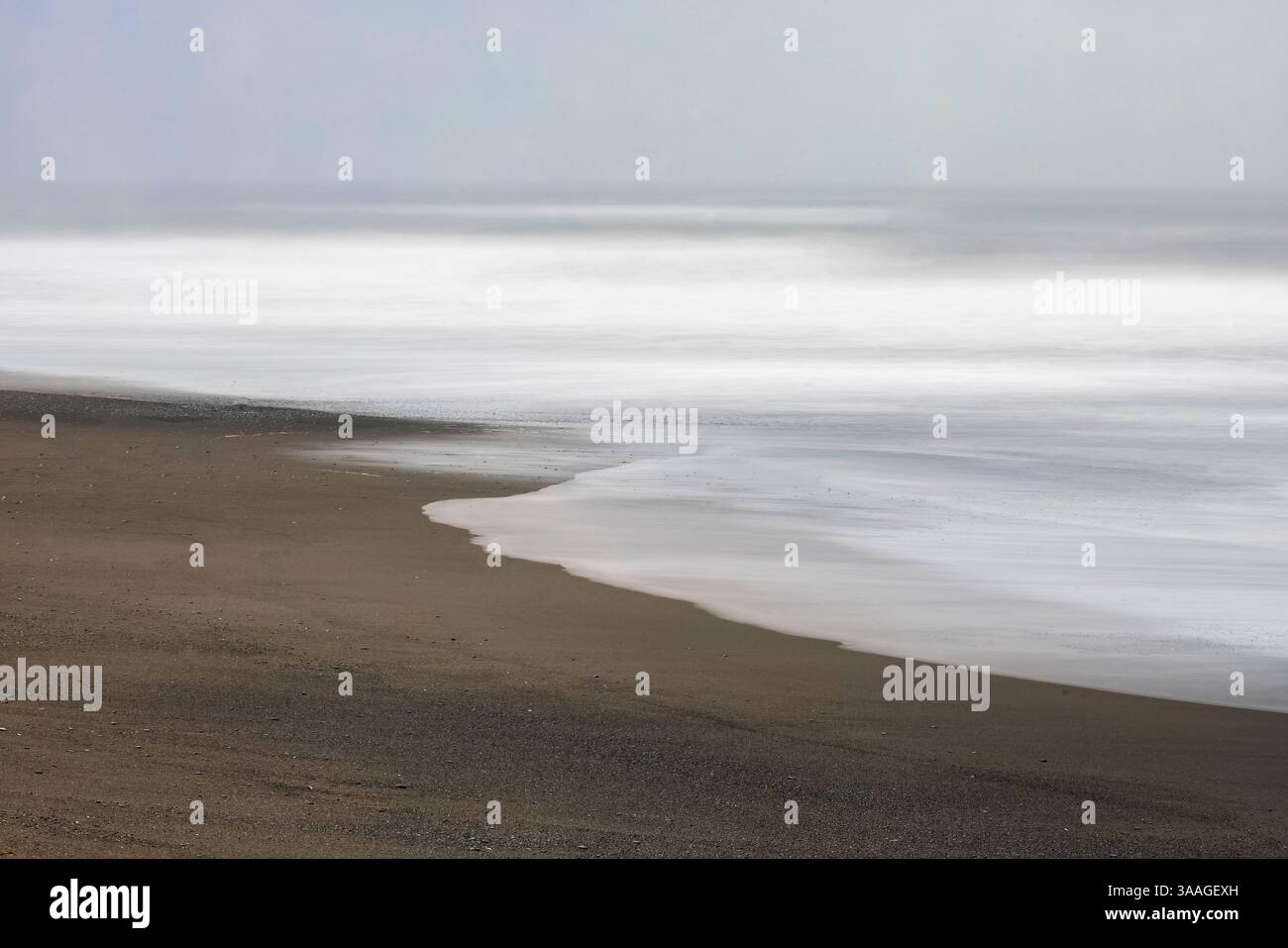 Long exposure of Pacific Ocean surf lapping up on Gold Bluffs Beach ...