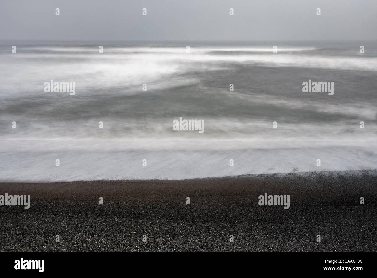 Long exposure of Pacific Ocean surf lapping up on Gold Bluffs Beach ...